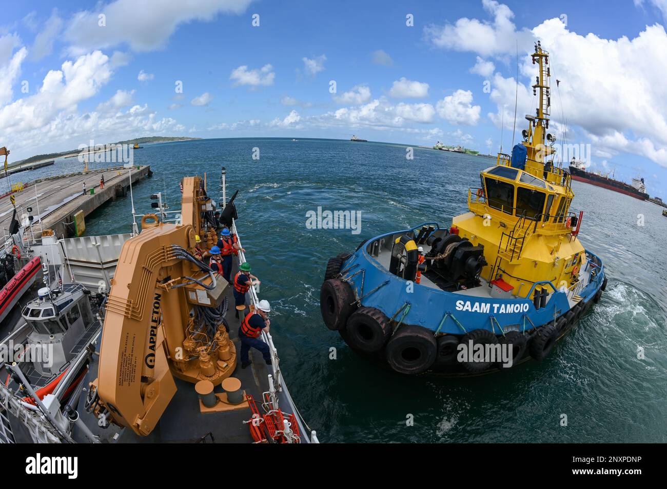 USCGC Stone (WMSL 758) crew members coordinate their departure with a ...