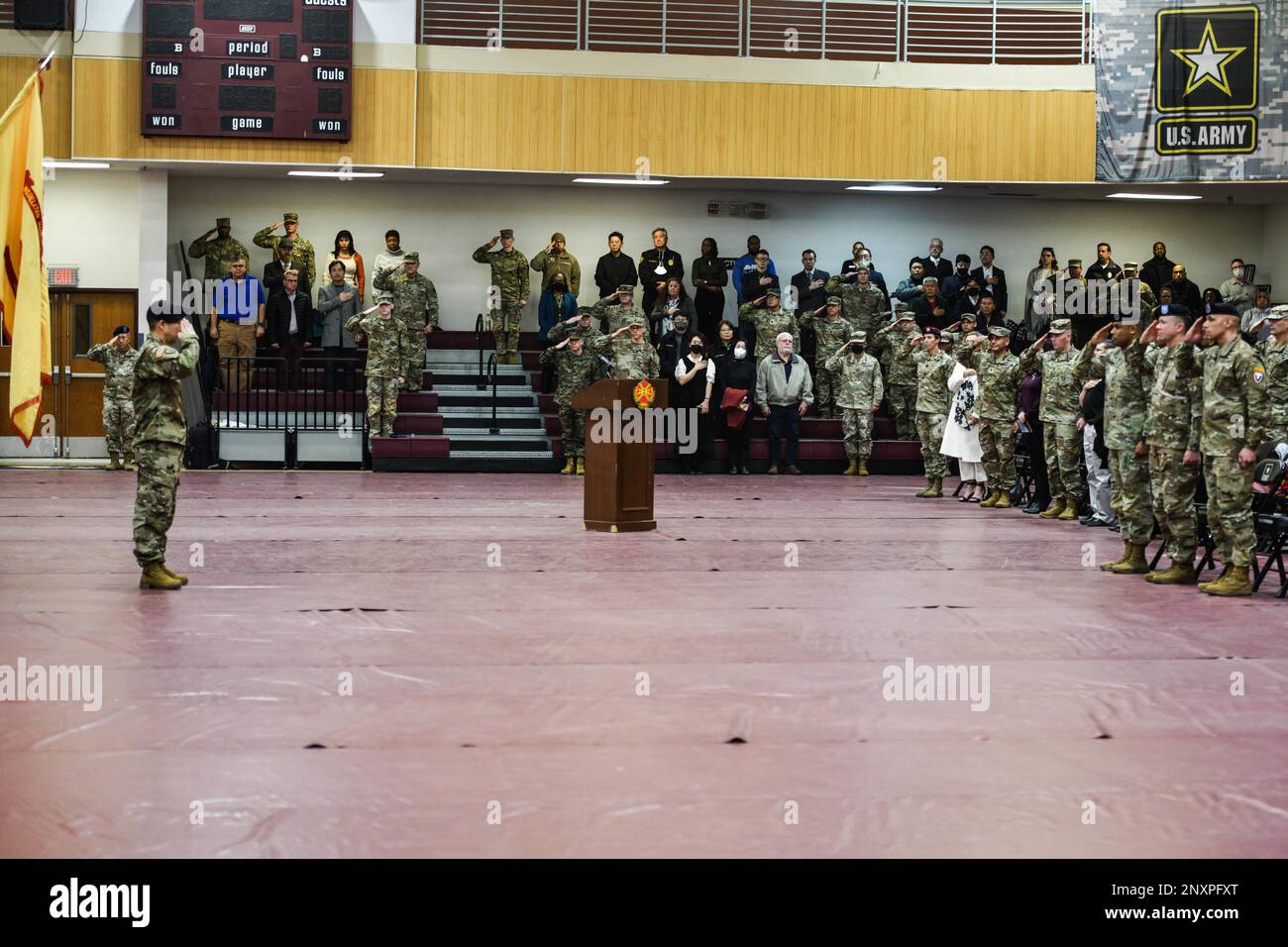 U.S. Army Soldiers and civilians render a salute when the national ...