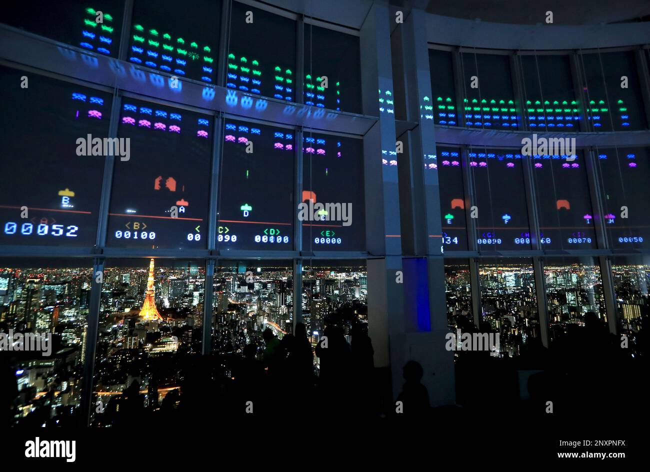 Space Invaders are projected on the window glasses of the Roppongi ...