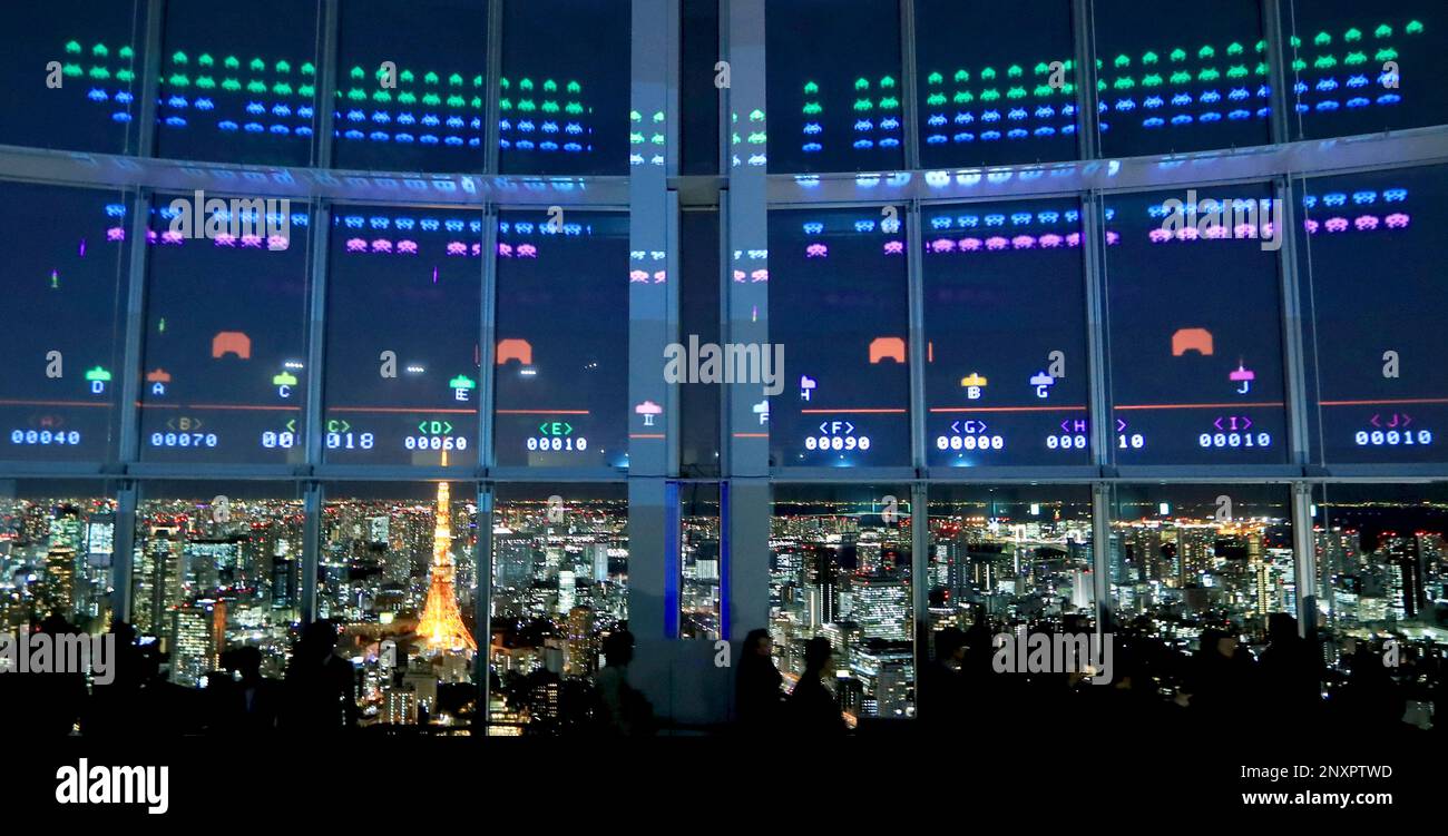 Space Invaders are projected on the window glasses of the Roppongi ...