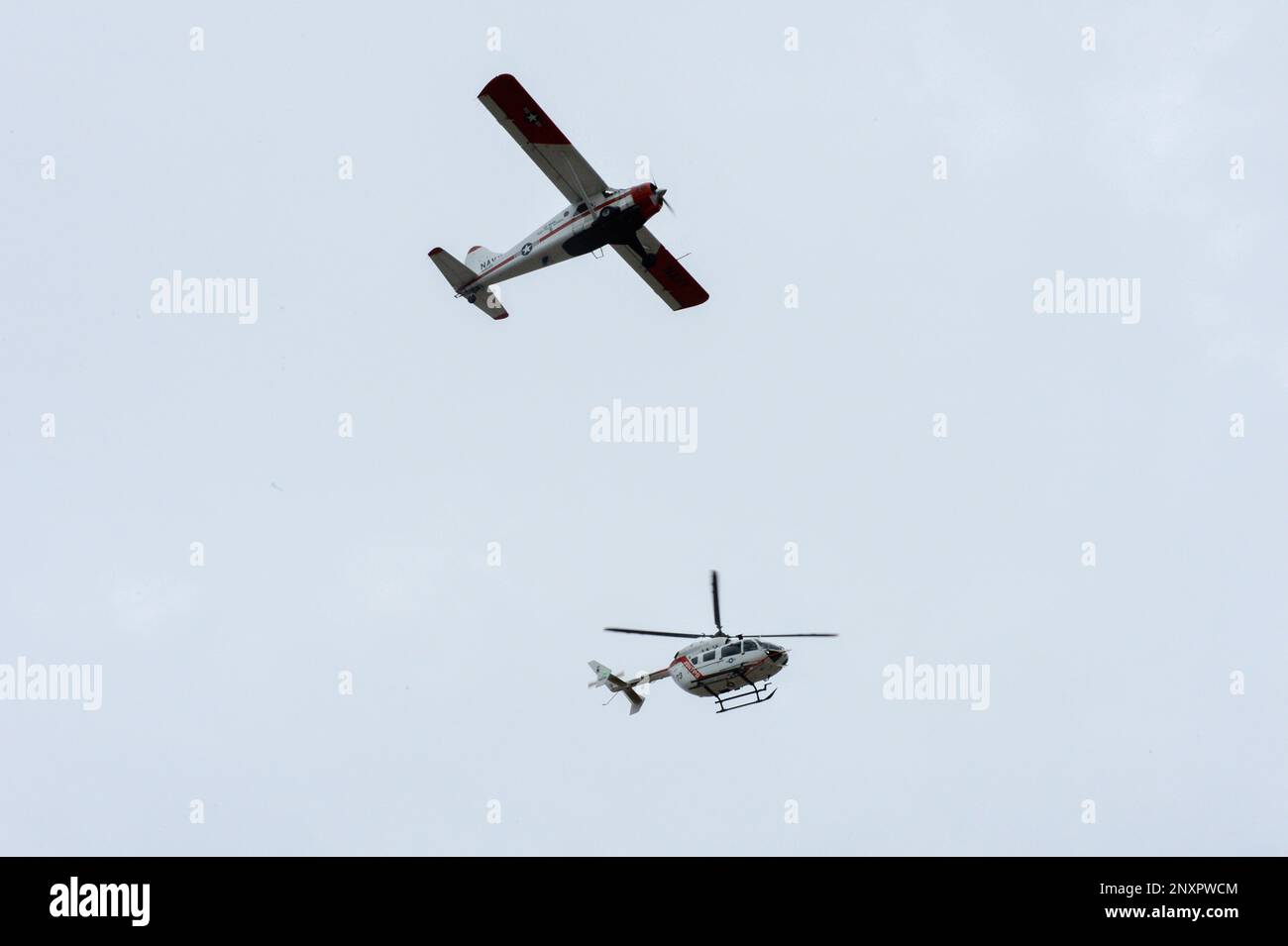 A U.S. Navy UH-72 Lakota and U-6A Beaver fly in formation over the U.S ...