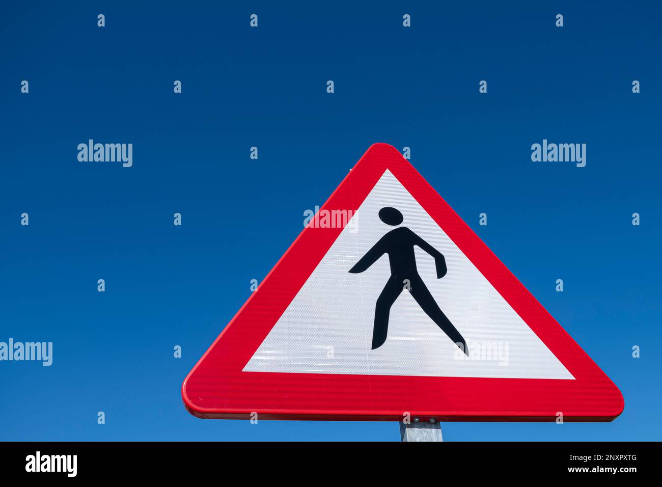 Traffic sign, pedestrian crossing danger over a blue sky Stock Photo ...
