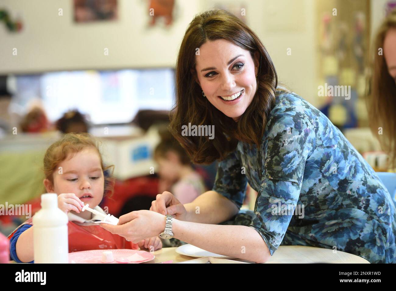 Kate, Duchess of Cambridge smiles as she interacts with children ...