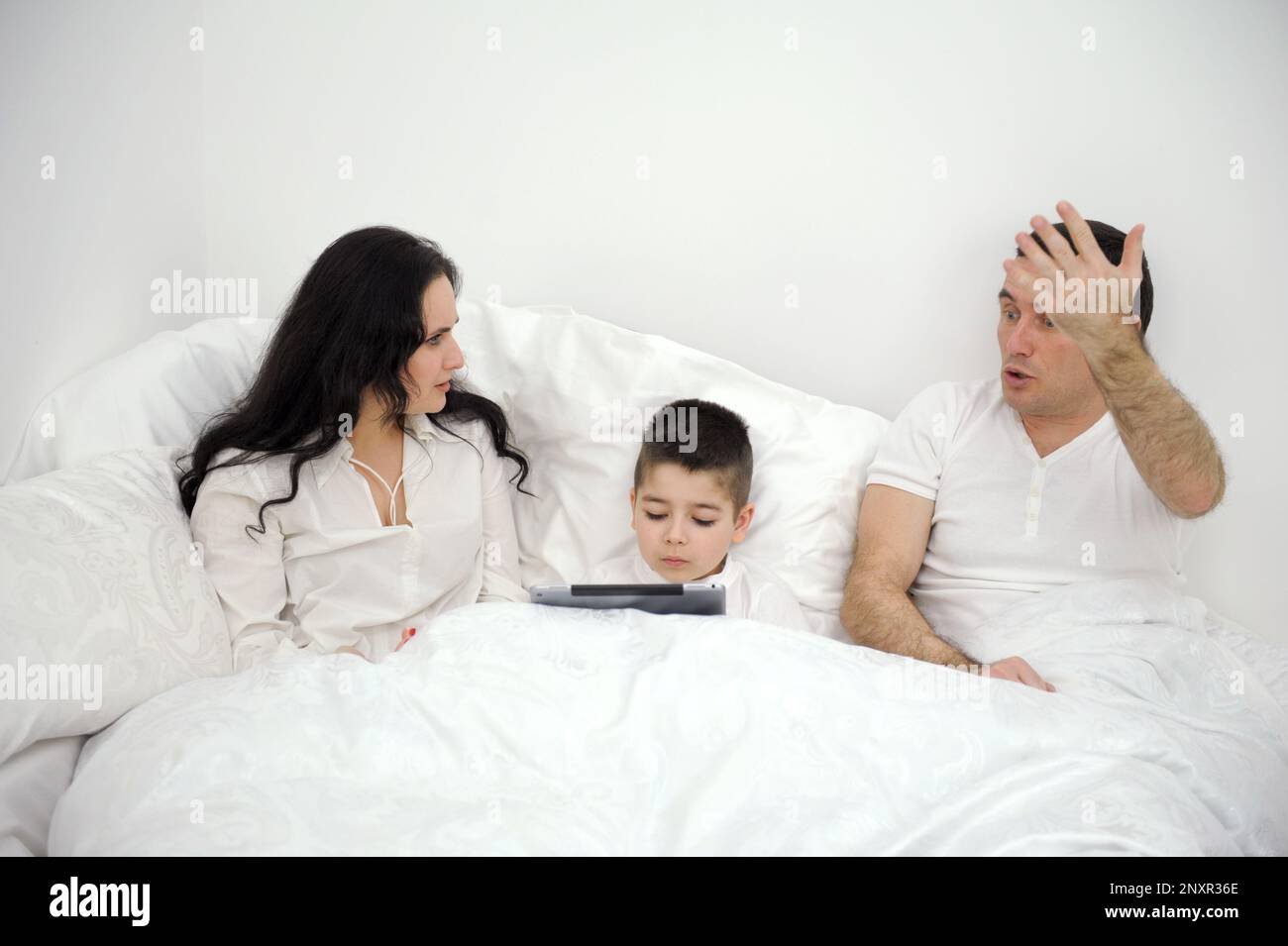 home disagreements parents quarrel in bed under covers son boy with ...