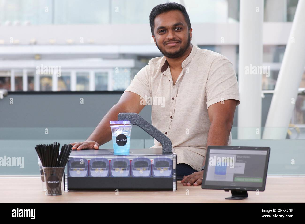 SUTD graduate Tushar Mohan photographed with Souschef, an automated drinks dispensing system ...
