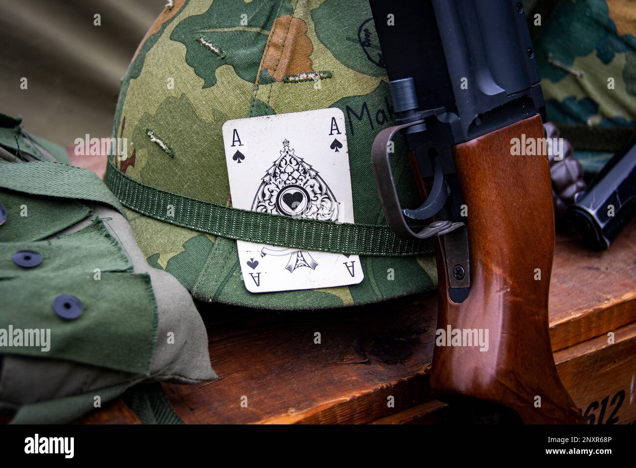 Military camouflage assault helmet with card and rifle Stock Photo - Alamy