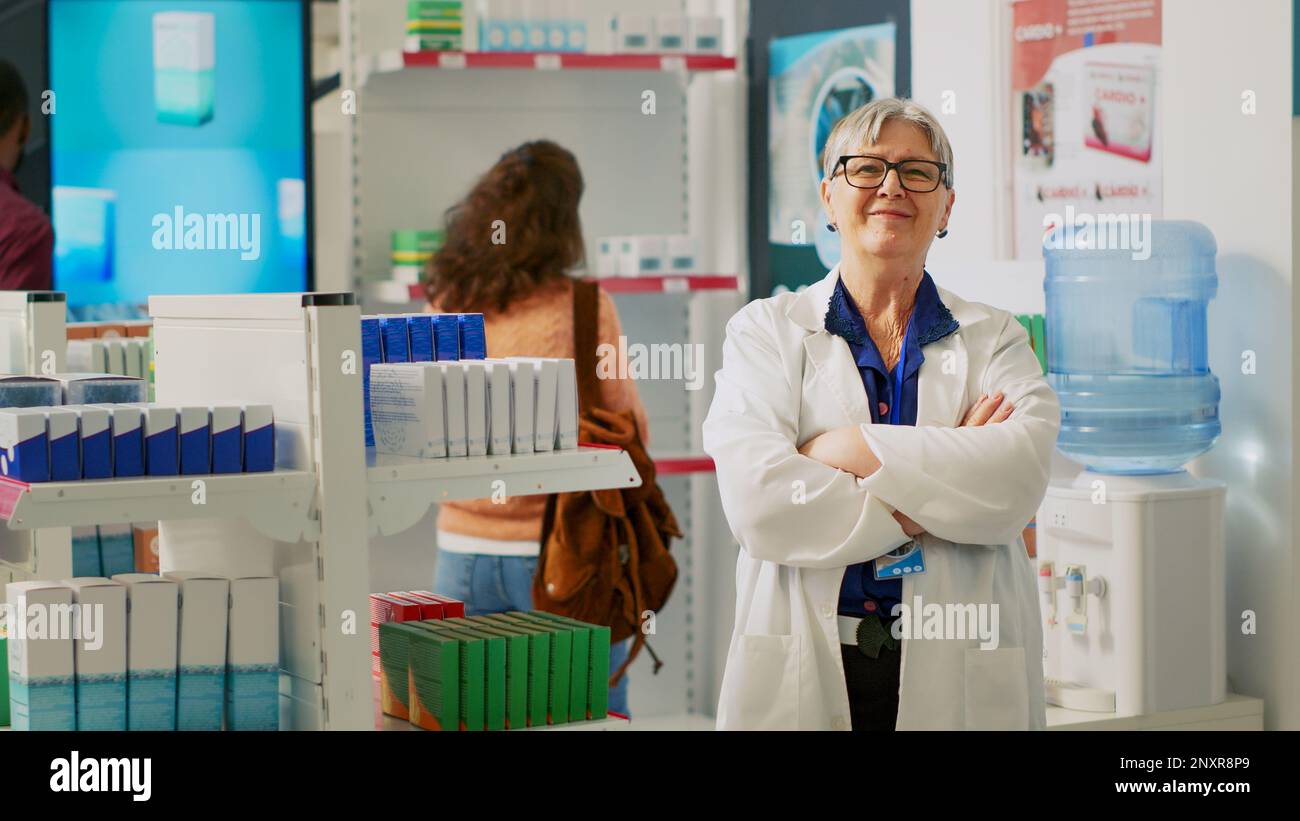 Female pharmacist arranging boxes hi-res stock photography and images ...