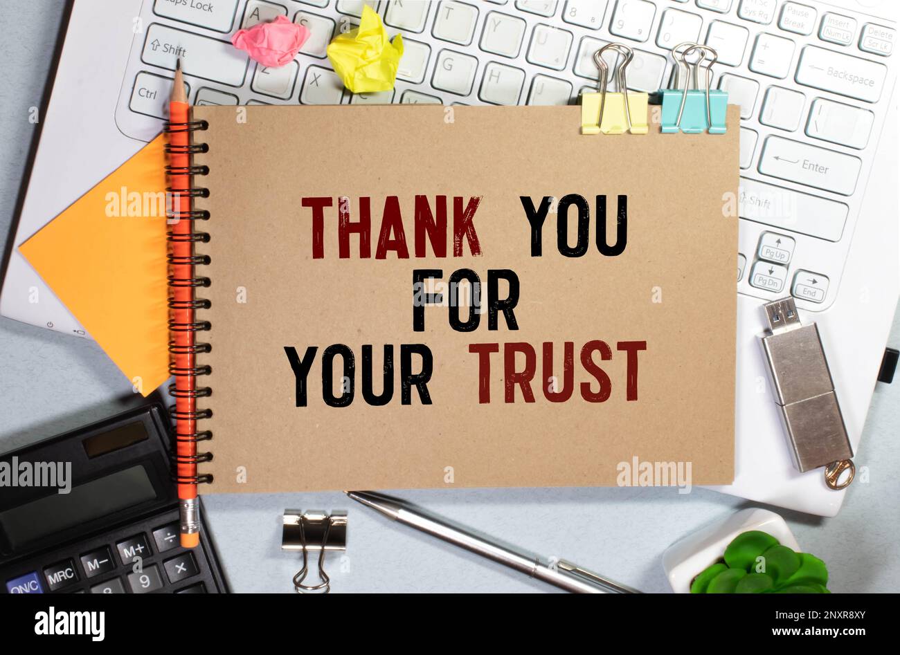 Thank you for your trust. text on white paper over torn paper background Stock Photo - Alamy