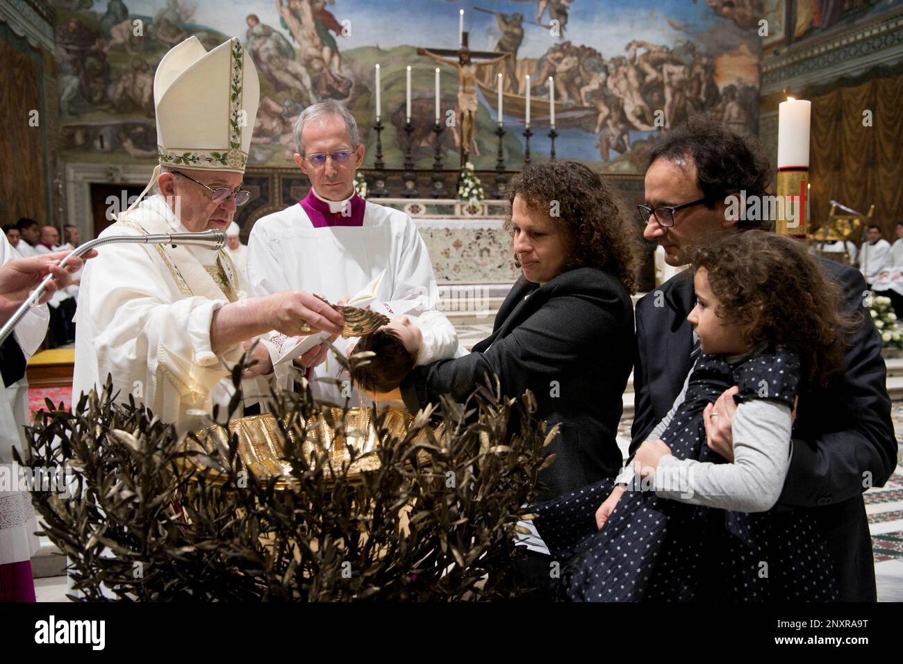 Pope Francis baptizes a baby at the Vatican, Sunday, Jan. 7, 2018. Pope ...