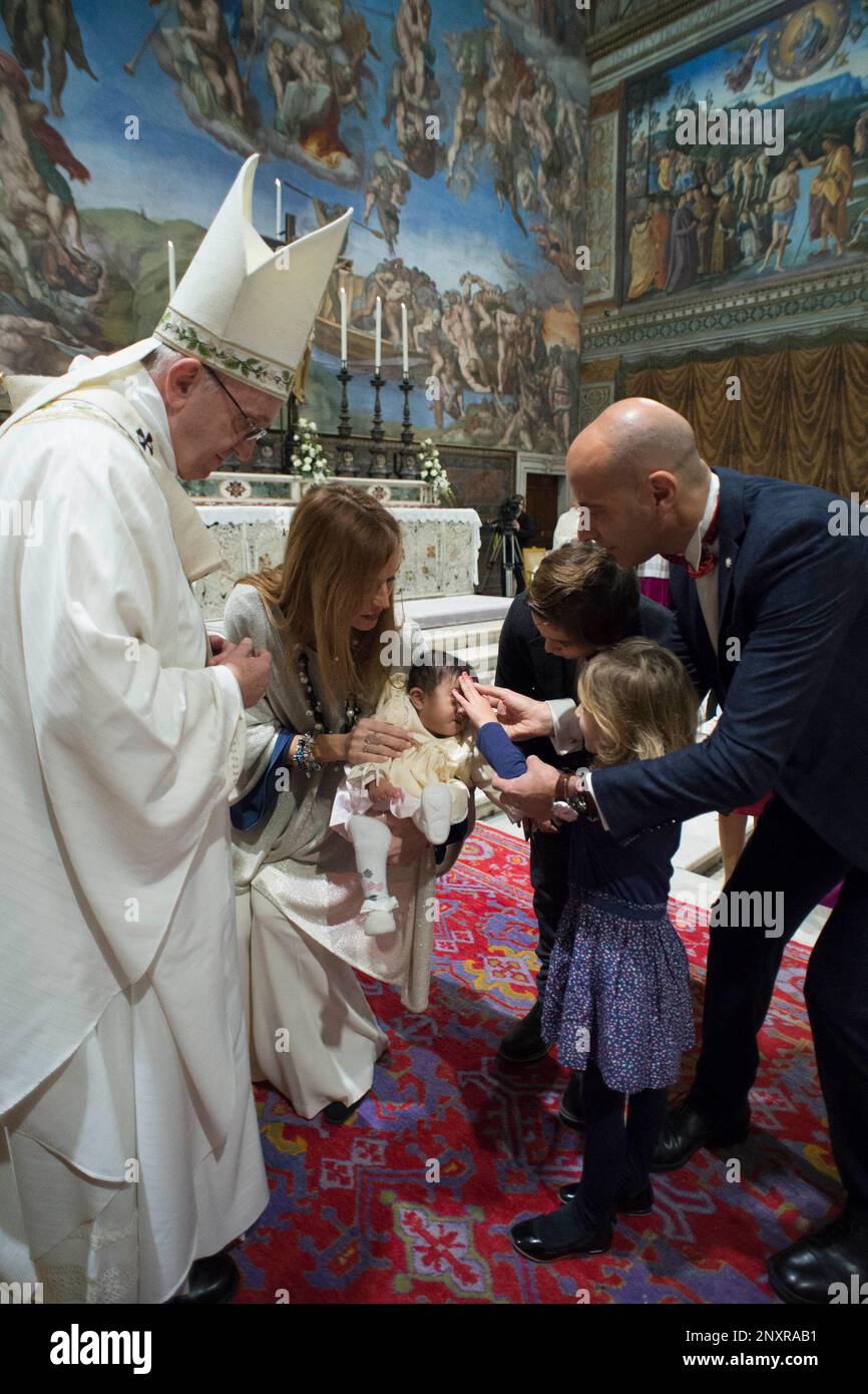 Pope Francis baptizes a baby at the Vatican, Sunday, Jan. 7, 2018. Pope ...