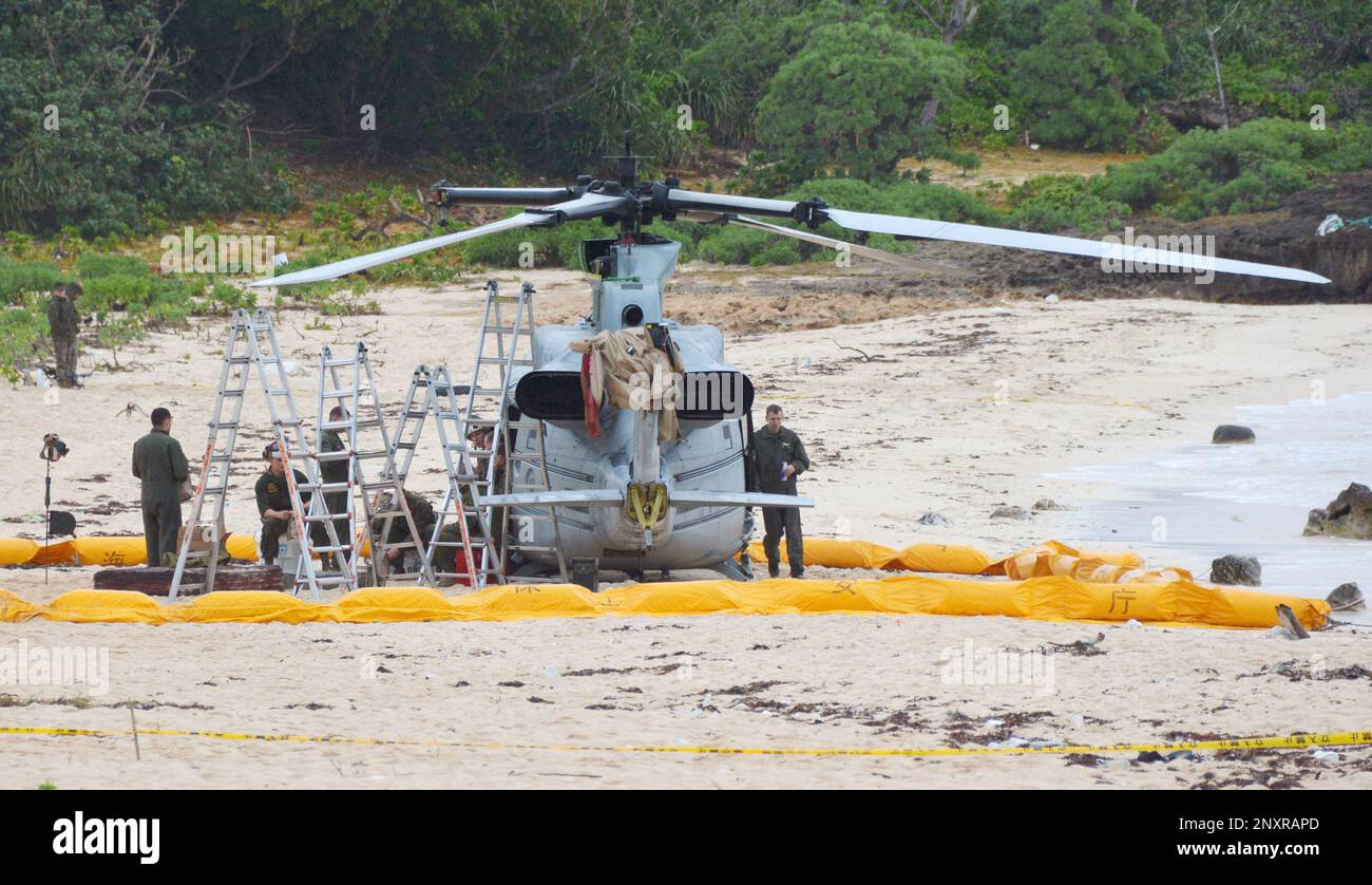 U.S. military personnel examine U.S. Marine Corps' UH-1Y helicopter ...