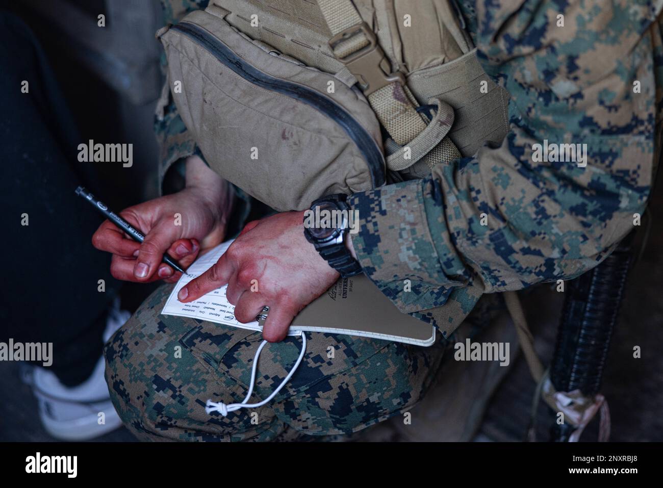 A U.S. Navy sailor with 1st Marine Division fills out a casualty triage ...