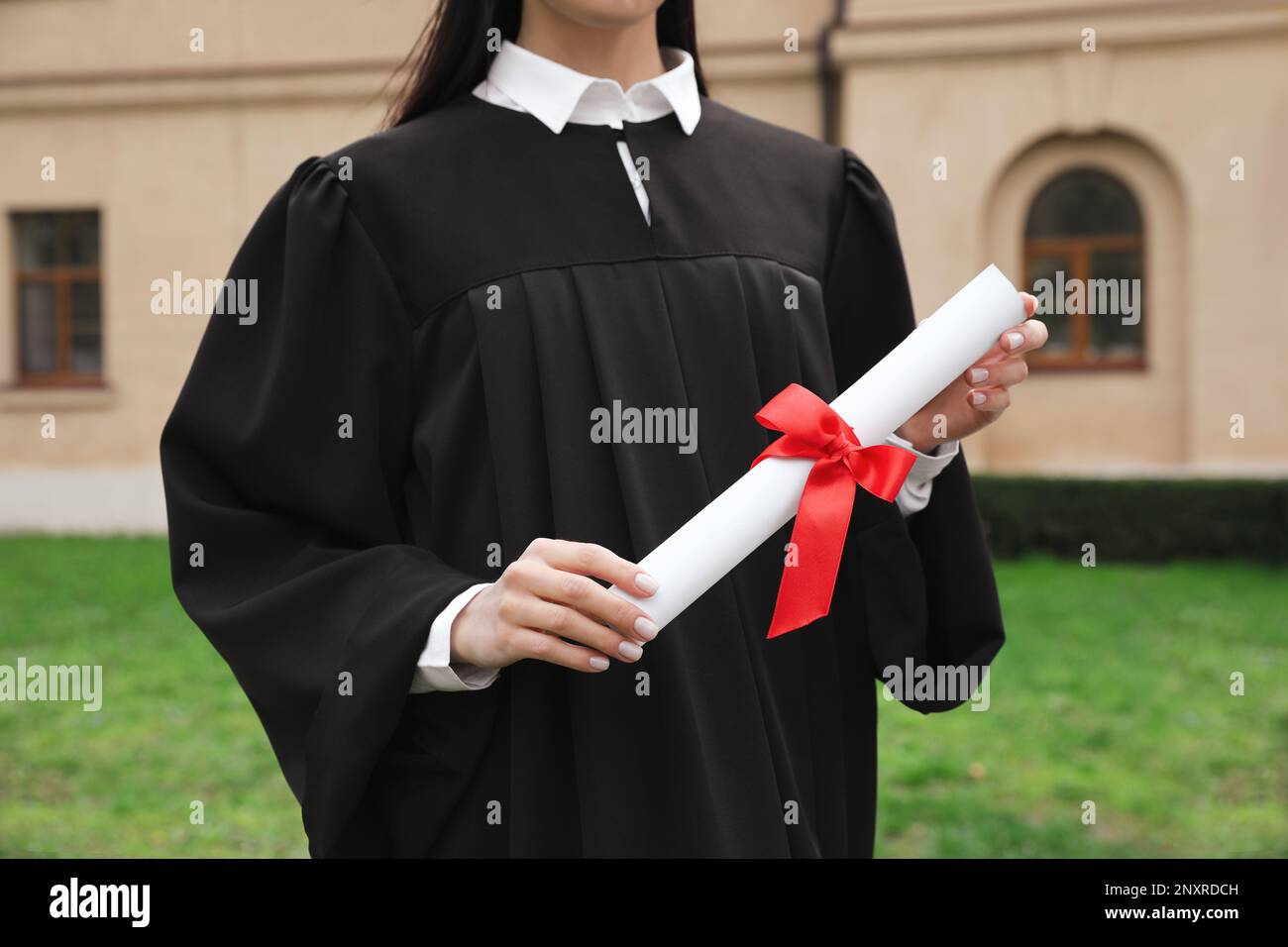 Student with diploma after graduation ceremony outdoors, closeup Stock ...