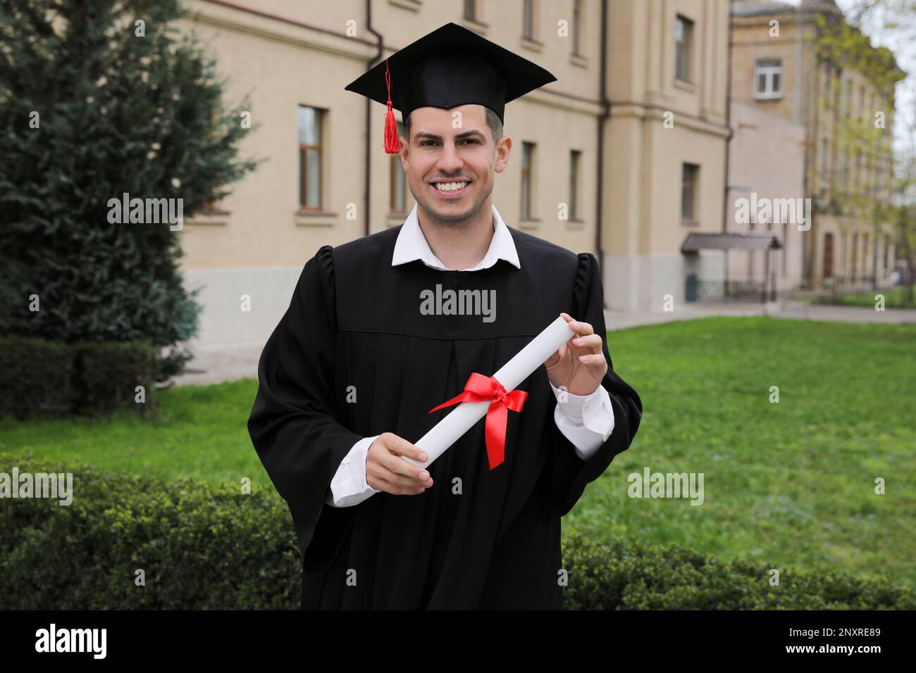 Happy student with diploma after graduation ceremony outdoors Stock ...