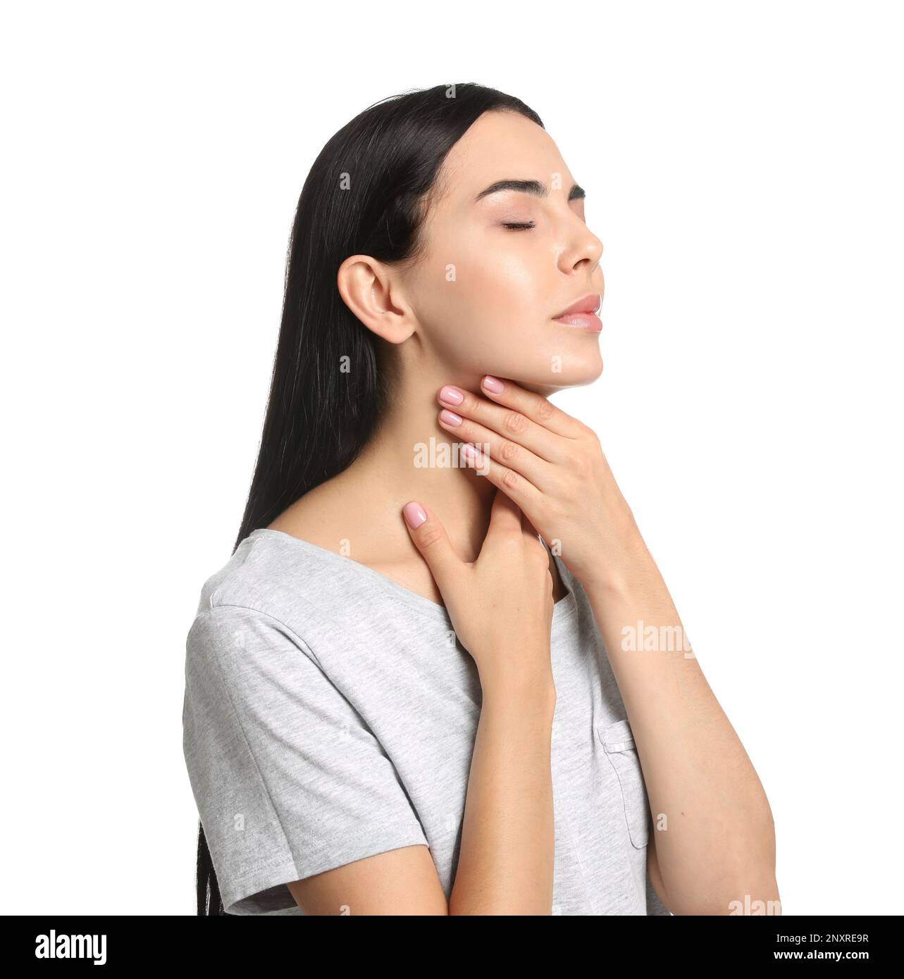 Young woman doing thyroid self examination on white background Stock ...