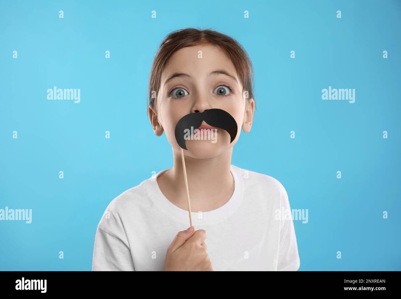 Cute little girl with fake mustache on turquoise background Stock Photo ...