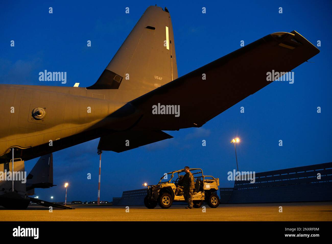 A U.S. Air Force loadmaster with the 67th Special Operations Squadron, guides a fellow ...