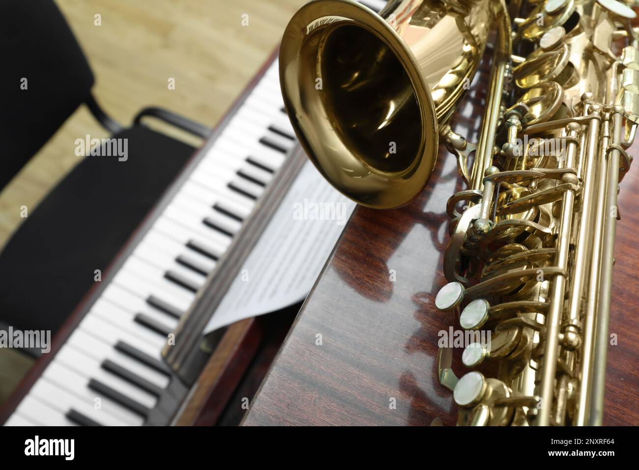Beautiful saxophone on piano, closeup. Space for text Stock Photo - Alamy