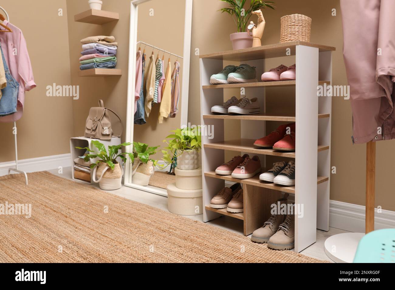 Stylish dressing room interior with shoes in storage unit Stock Photo ...