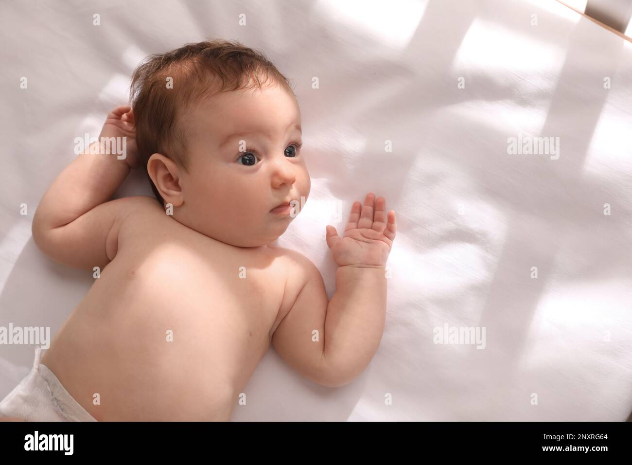 Cute little baby on bed, top view Stock Photo - Alamy