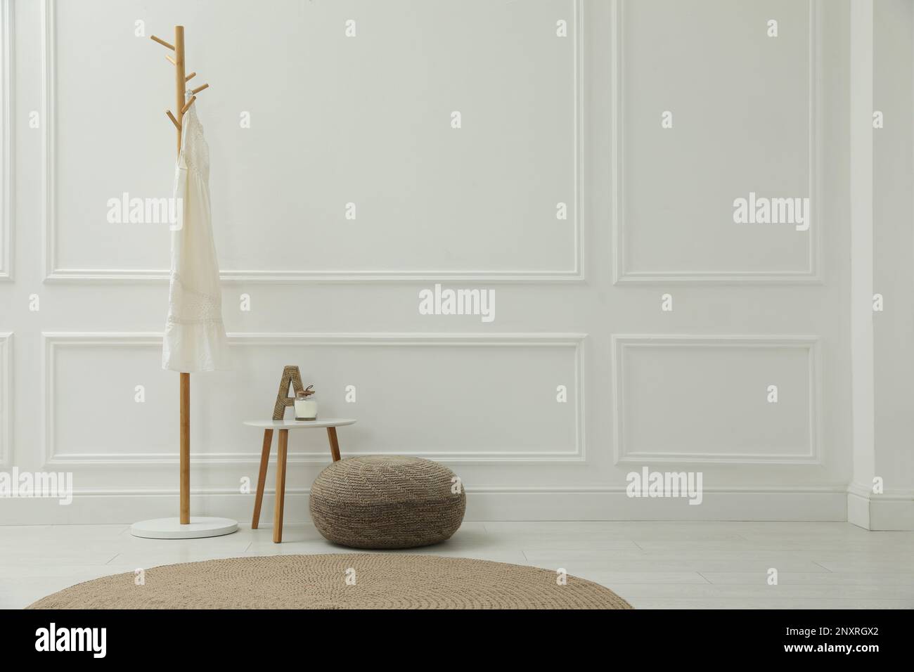 Simple hall interior with pouf, clothes rack and decor elements. Space ...