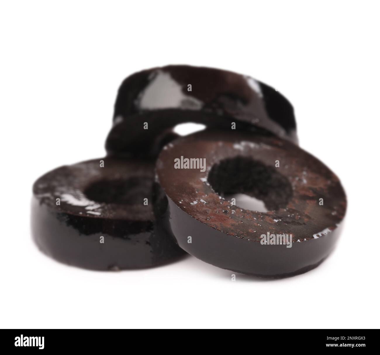 Cut fresh black olives on white background Stock Photo - Alamy