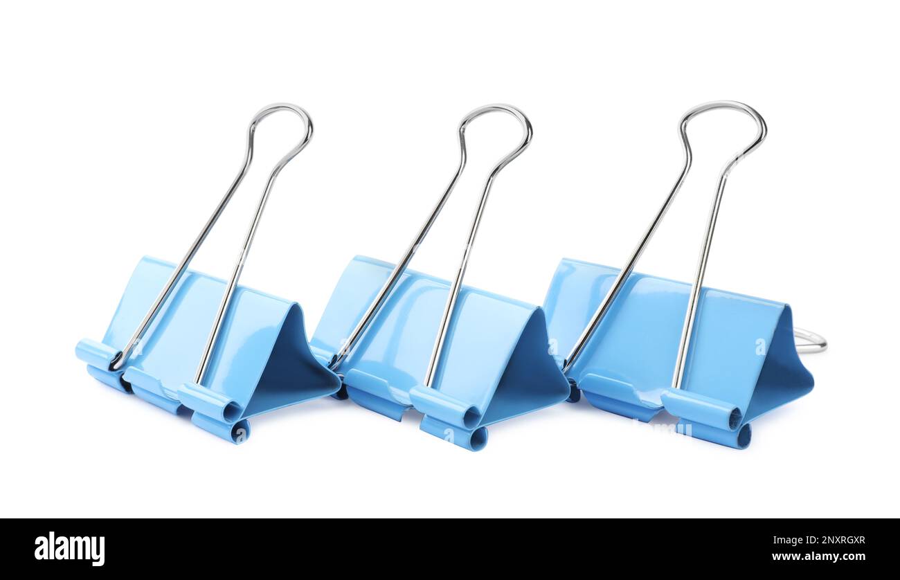 Light blue binder clips on white background. Stationery Stock Photo - Alamy