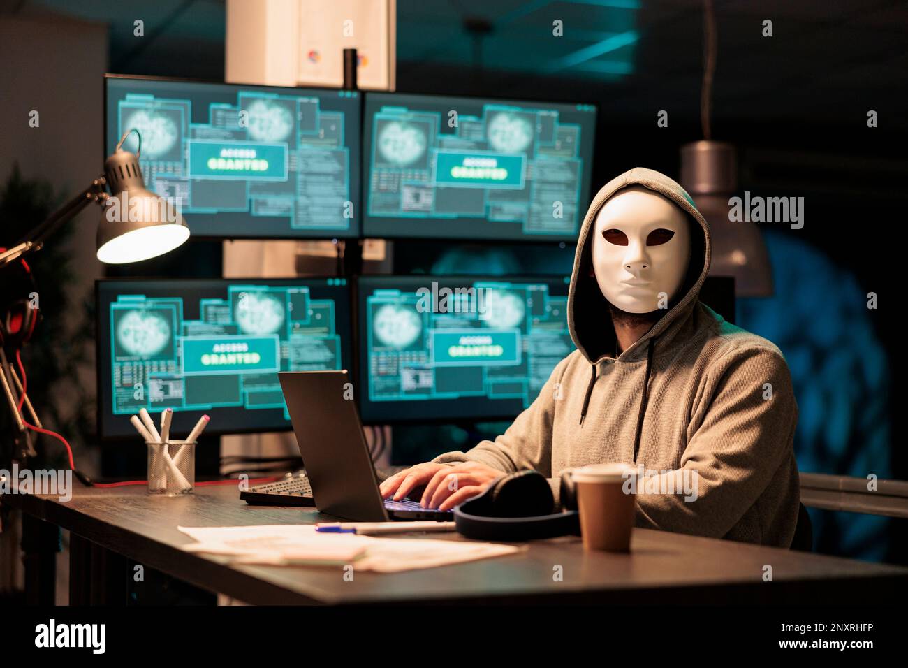 Hacker Wearing Mask And Hood To Hack Computer System Breaking Into