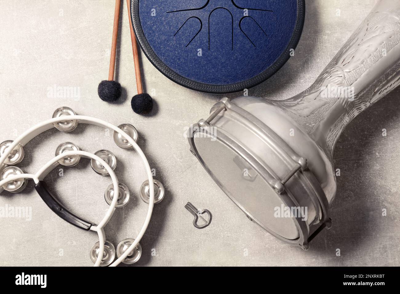 Different percussion musical instruments on light grey background, flat ...