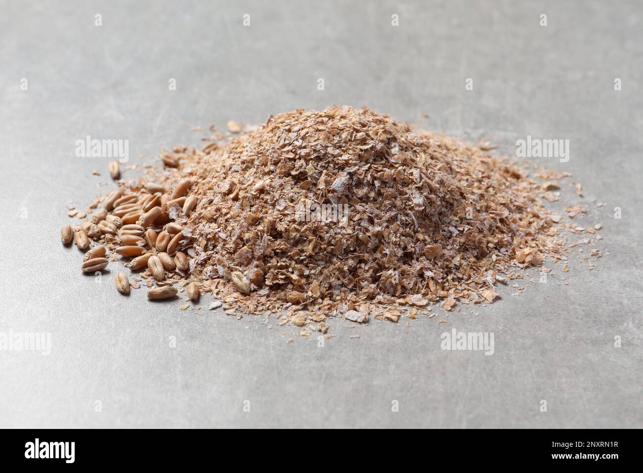 Pile of wheat bran on grey table Stock Photo - Alamy