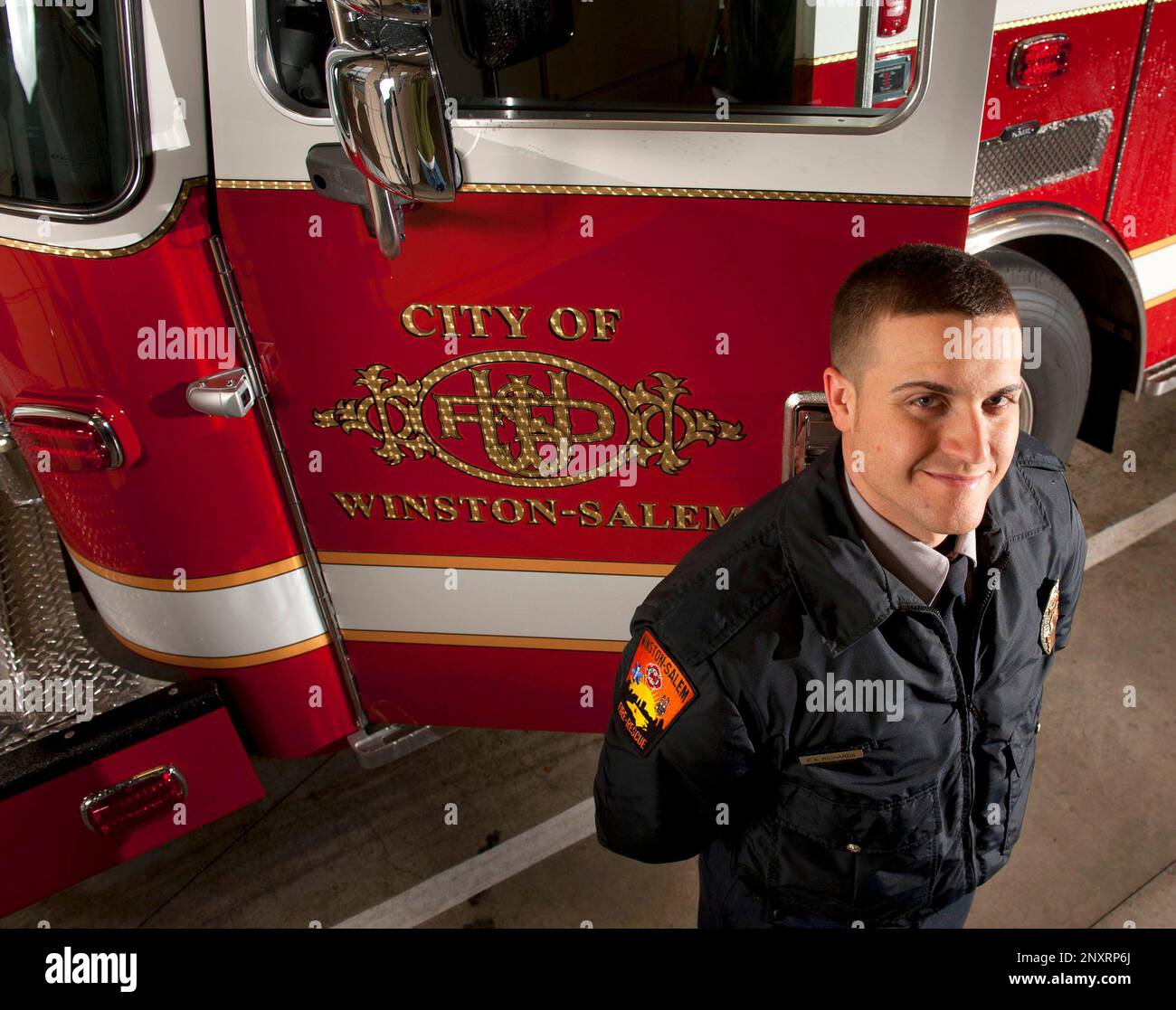Firefighter Ethan Richards stands next to the new logo he designed for ...