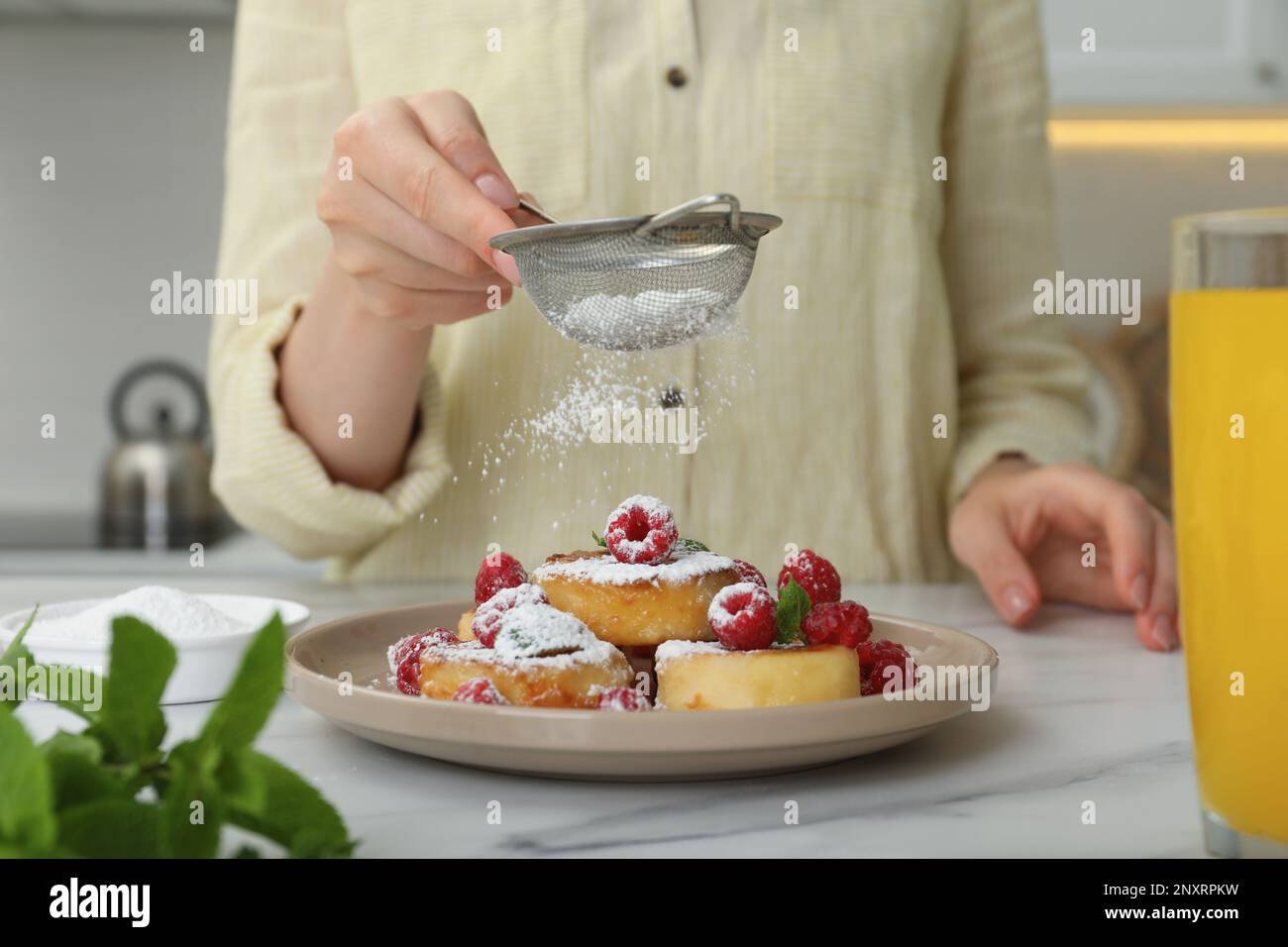 Woman sieving powdered sugar hi-res stock photography and images - Alamy