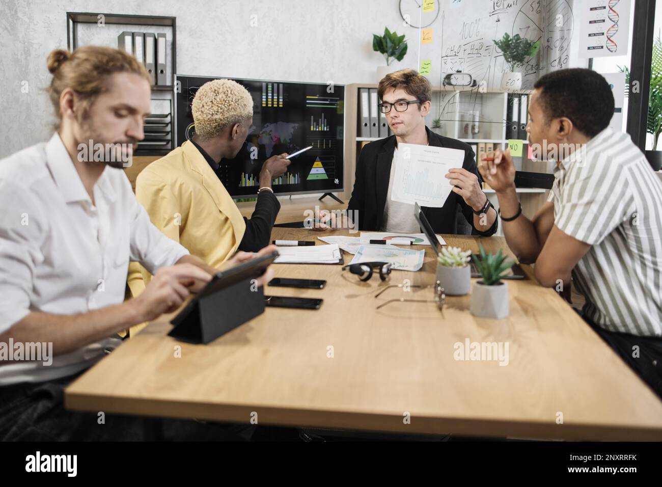 Team of multicultural male traders having negotiation at office room ...