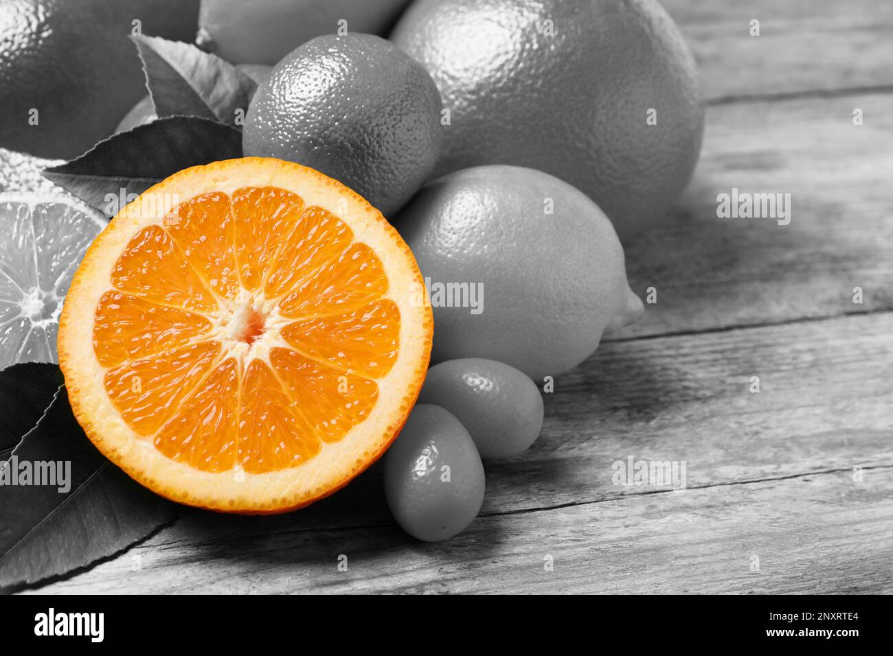 Fresh juicy citrus fruits on wooden table. Black and white tone with ...