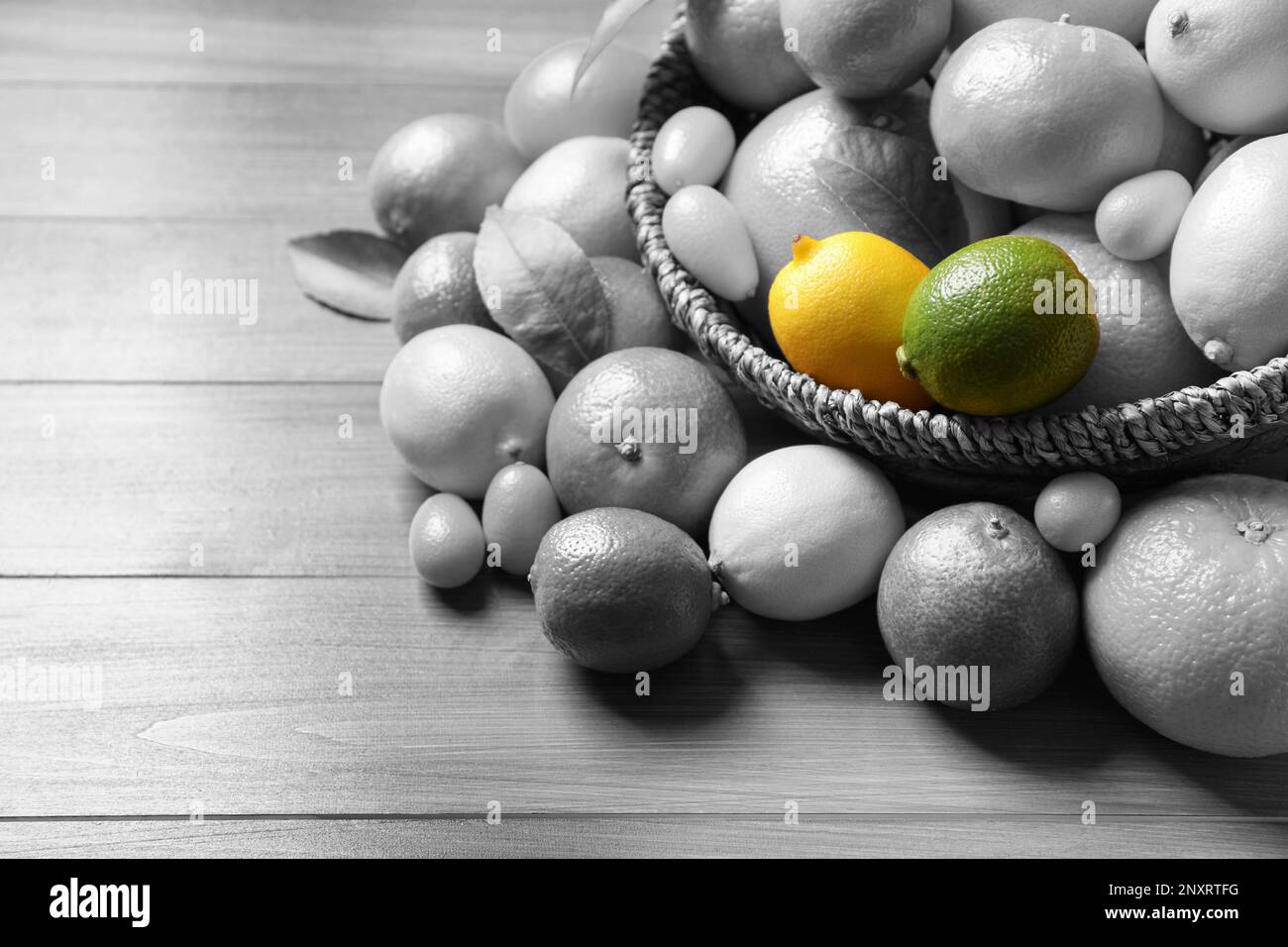 Different citrus fruits on wooden table. Black and white tone with ...