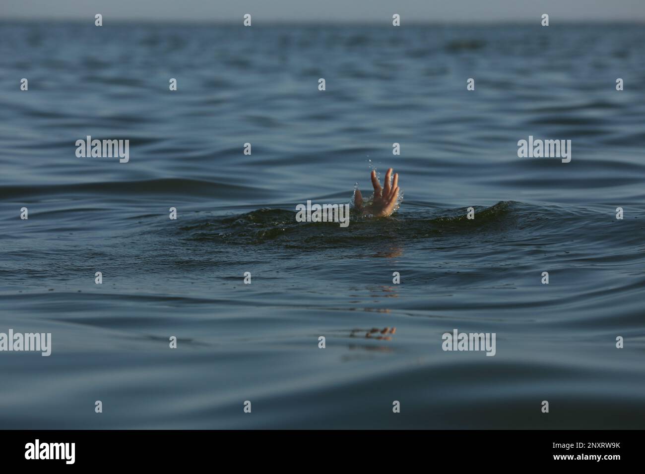 Drowning woman reaching for help in sea Stock Photo - Alamy