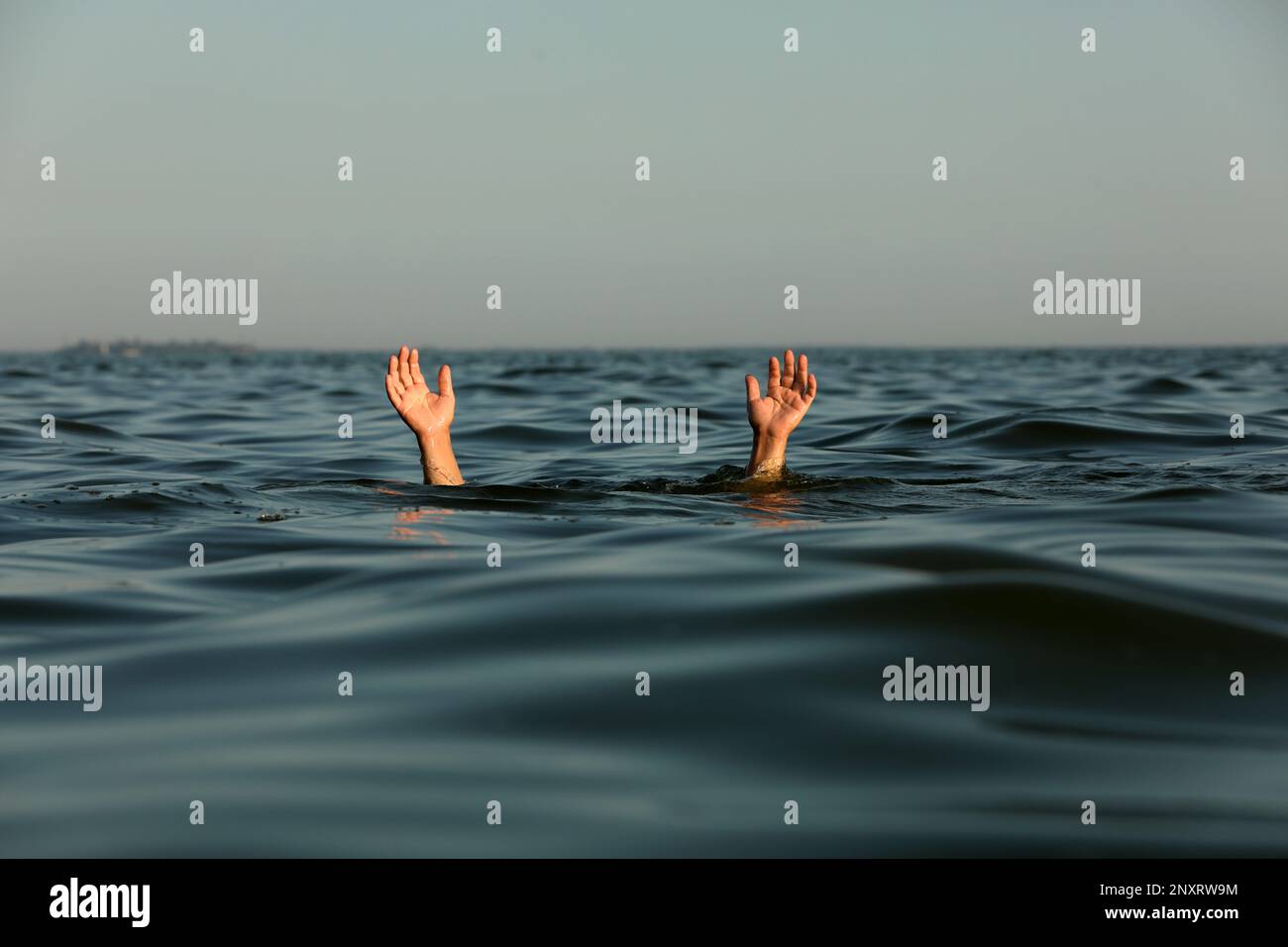 Drowning man reaching for help in sea Stock Photo - Alamy