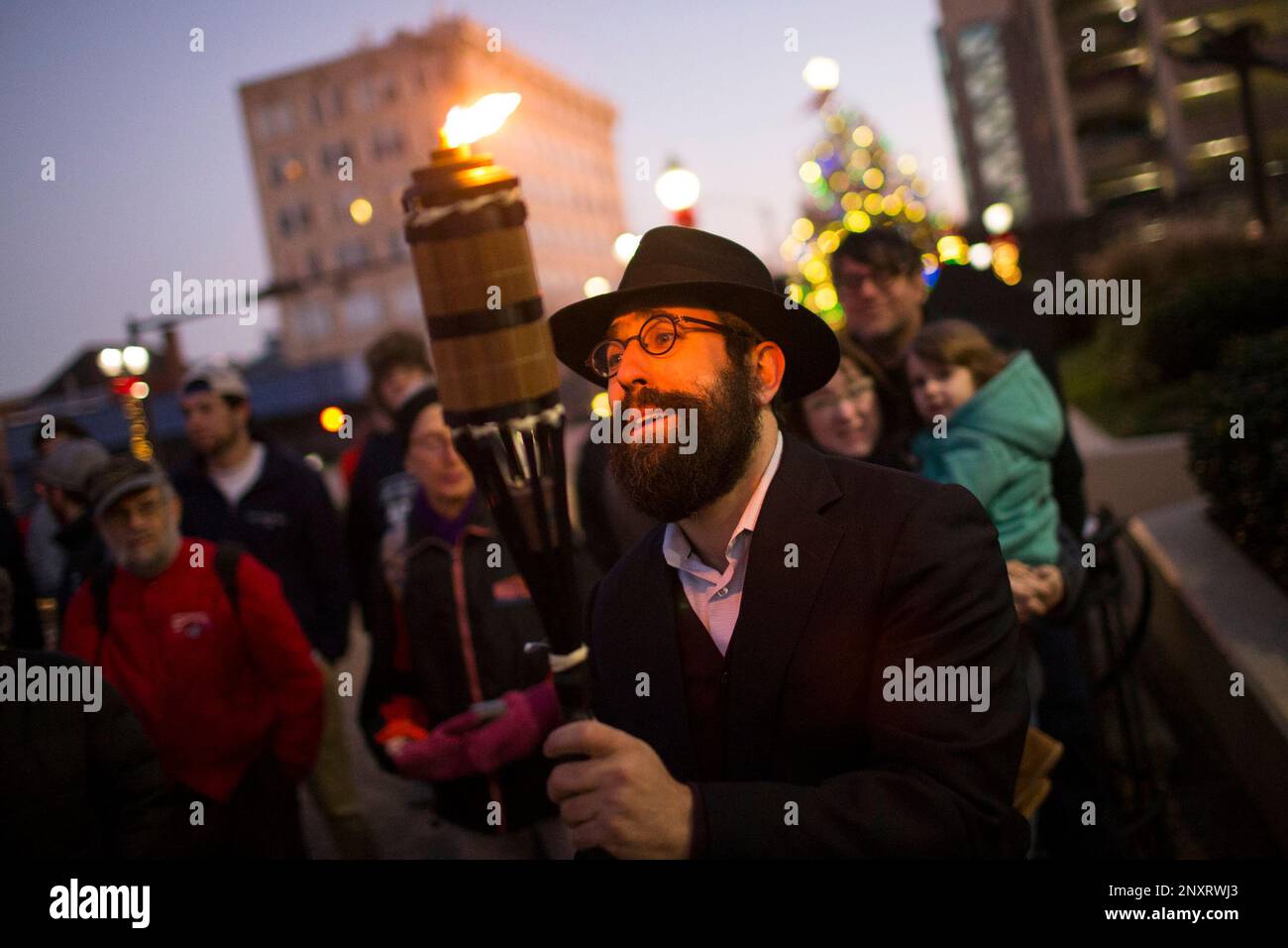 Rabbi Michoel Refson of Chabad of Athens moves to light the Menorah to ...