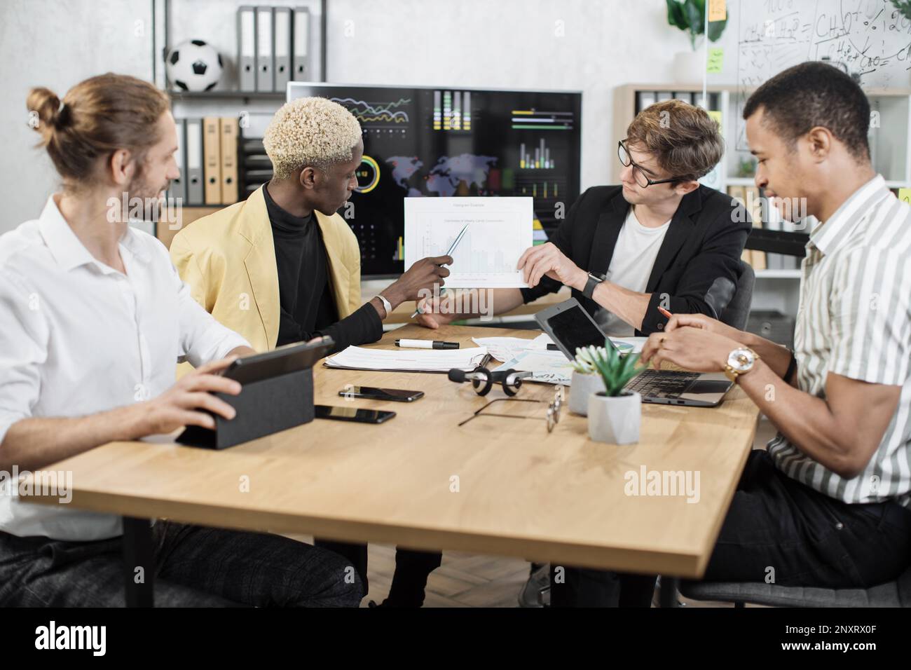 Team of multicultural male traders having negotiation at office room ...