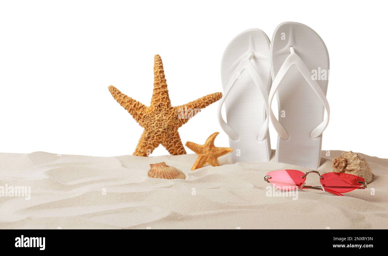 Bright flip flops, starfishes, sea shells and sunglasses on sand against white background Stock ...