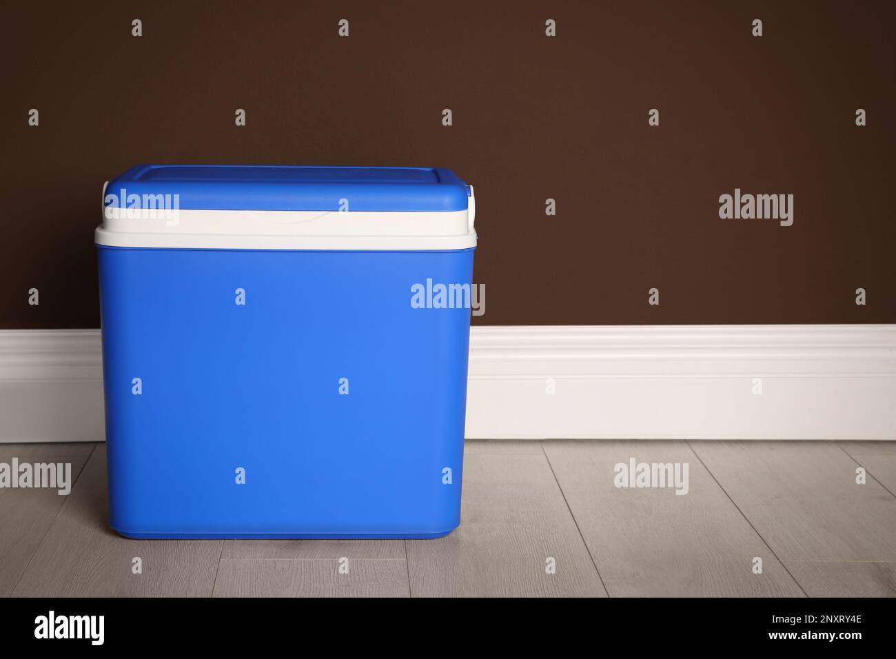 Closed blue plastic cool box near brown wall. Space for text Stock ...