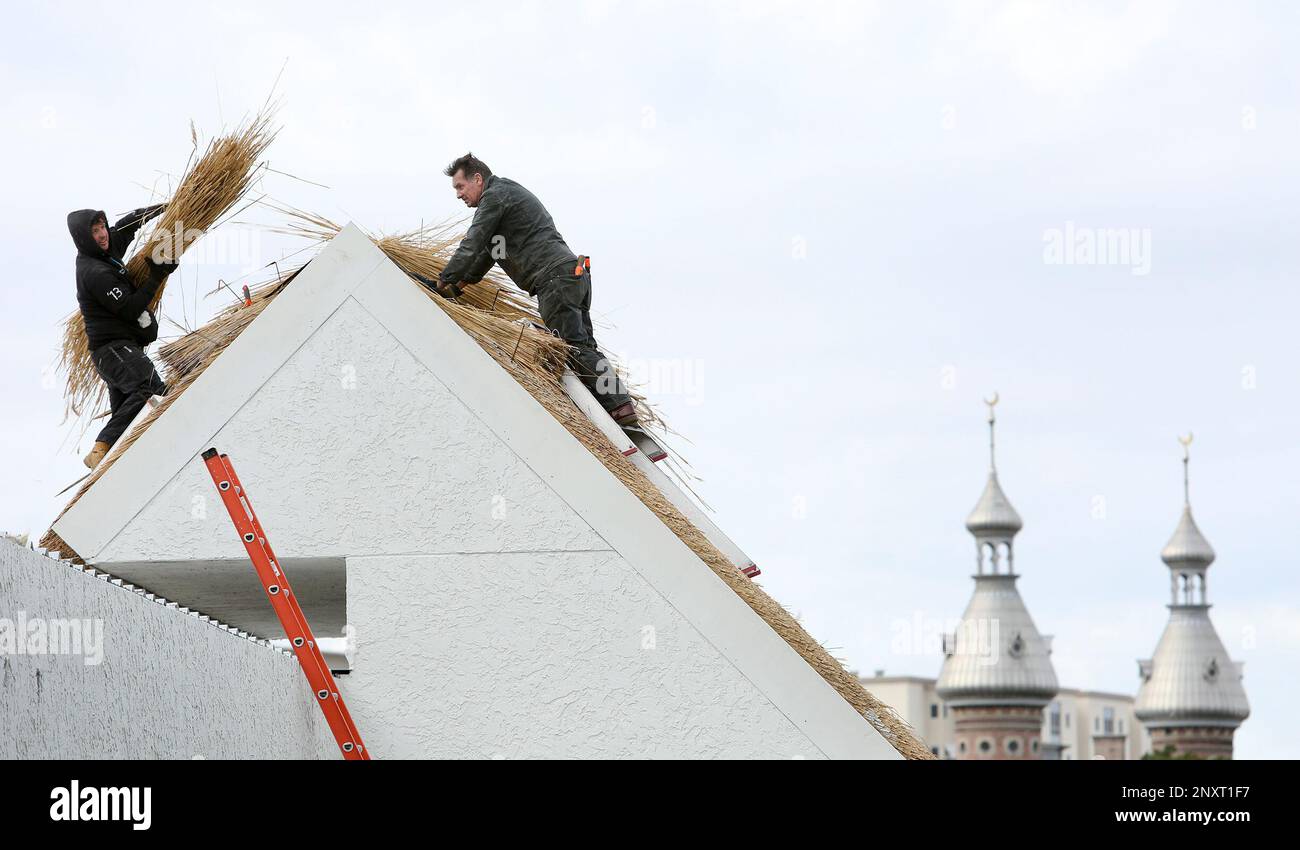 Matthew Spittle, left, hauls up a armful of water reeds as he and Colin ...