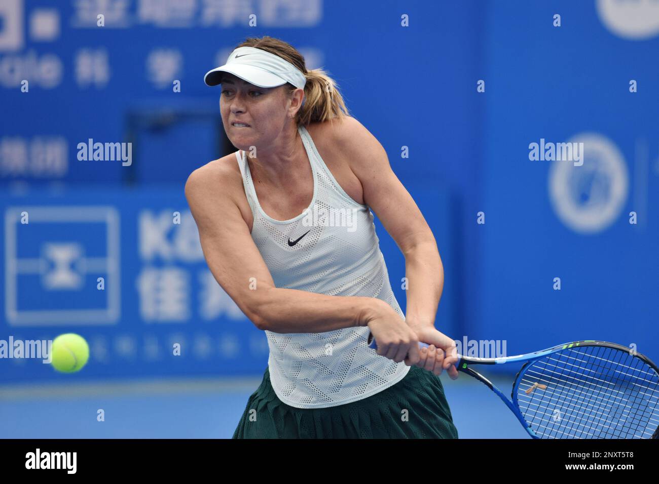 Maria Sharapova of Russia returns a shot to Mihaela Buzarnescu of ...