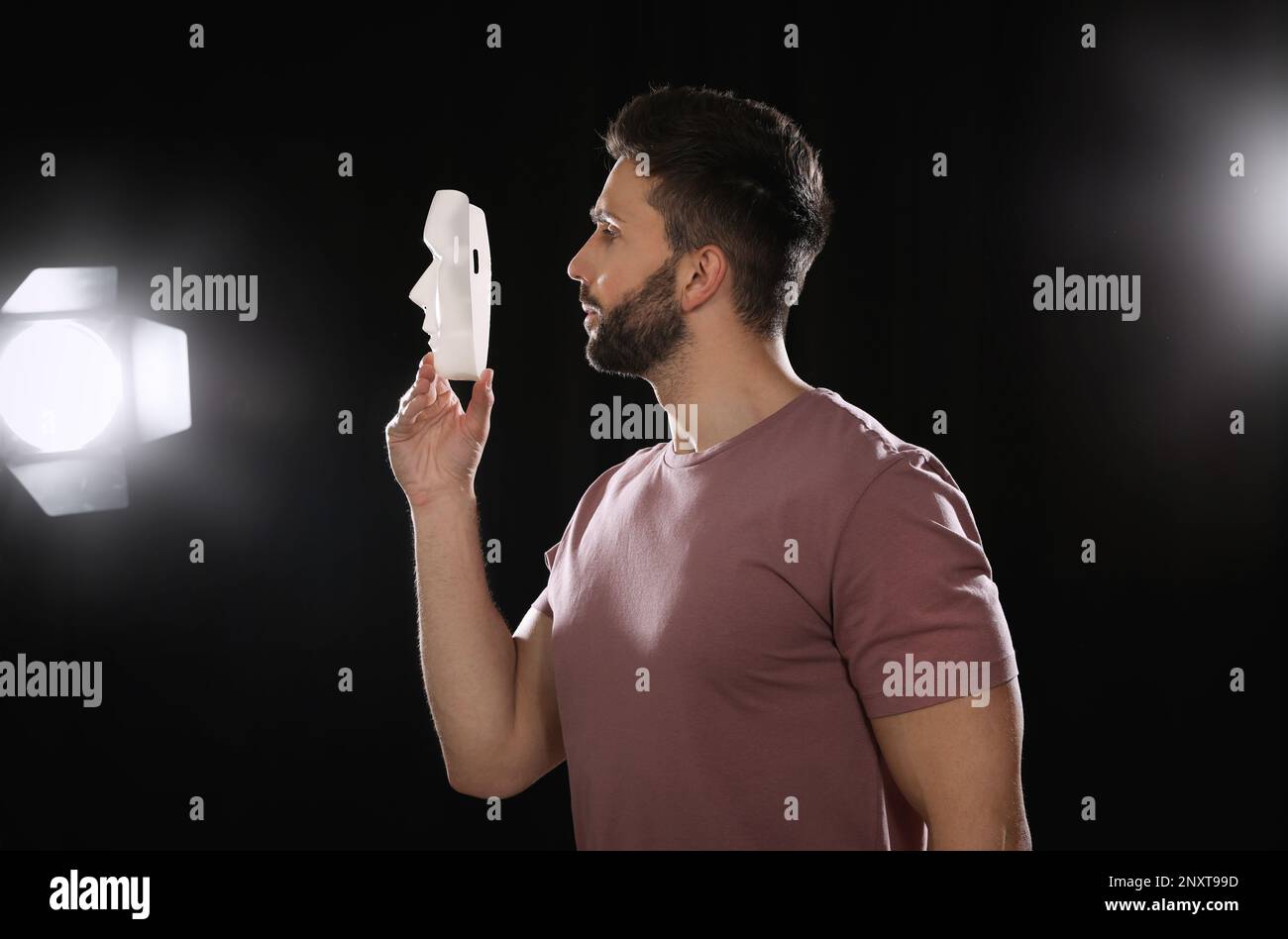 Professional actor rehearsing with mask on stage in theatre Stock Photo ...