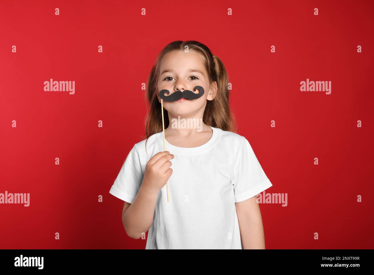 Little girl with fake mustache on red background Stock Photo - Alamy