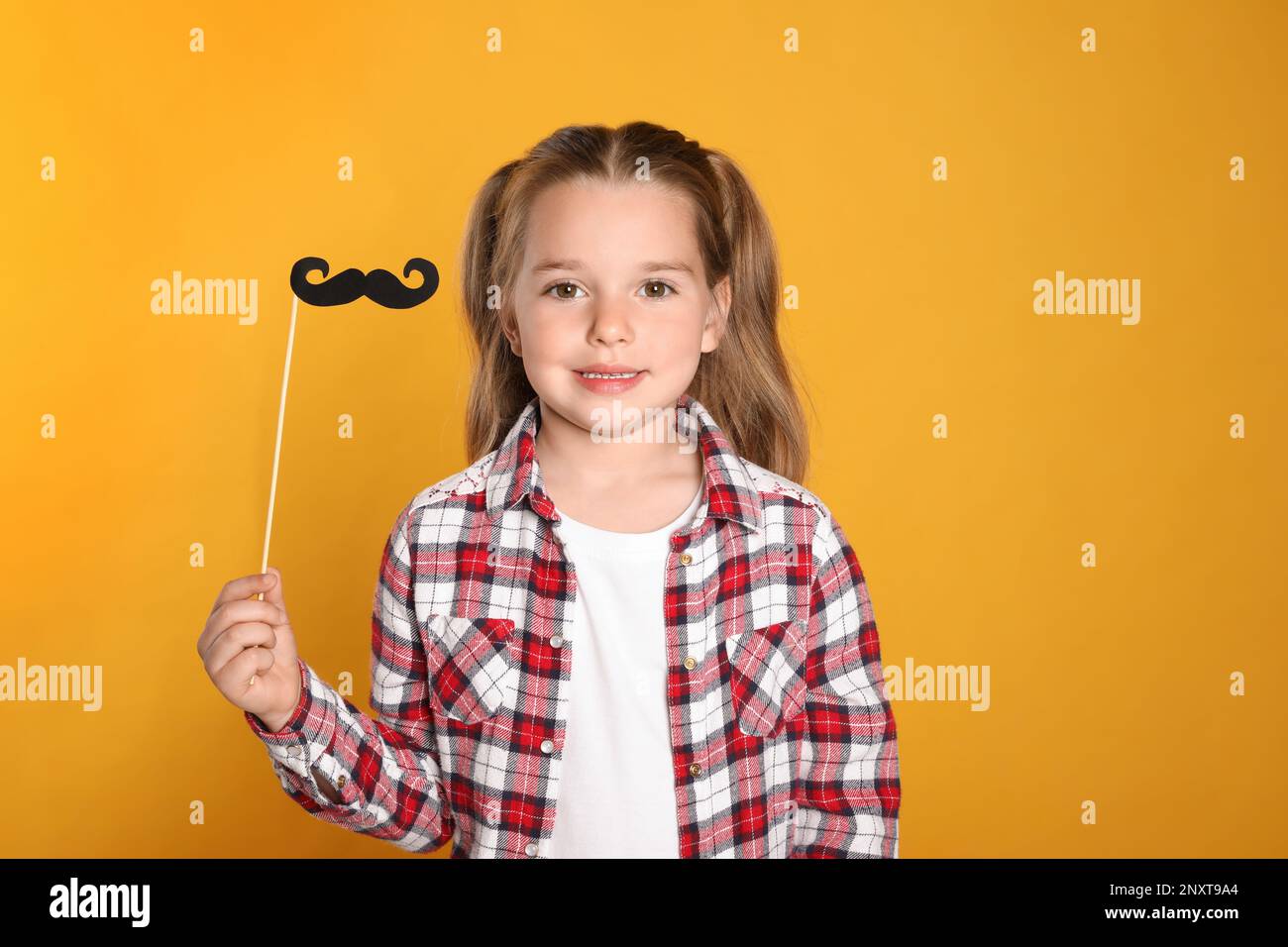 Little girl with fake mustache on yellow background Stock Photo - Alamy