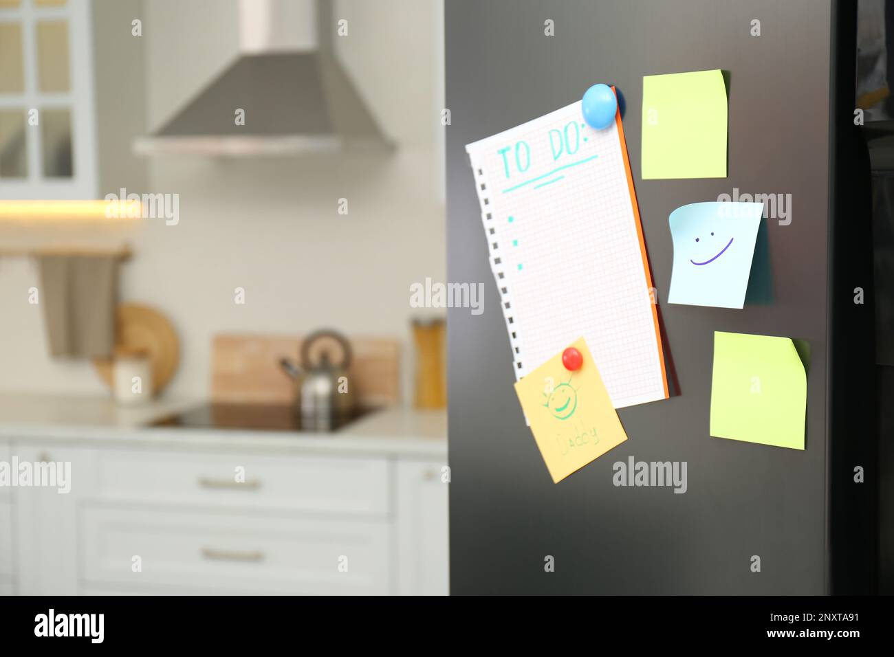 Blank to do list and sticky notes on fridge in kitchen. Space for text ...