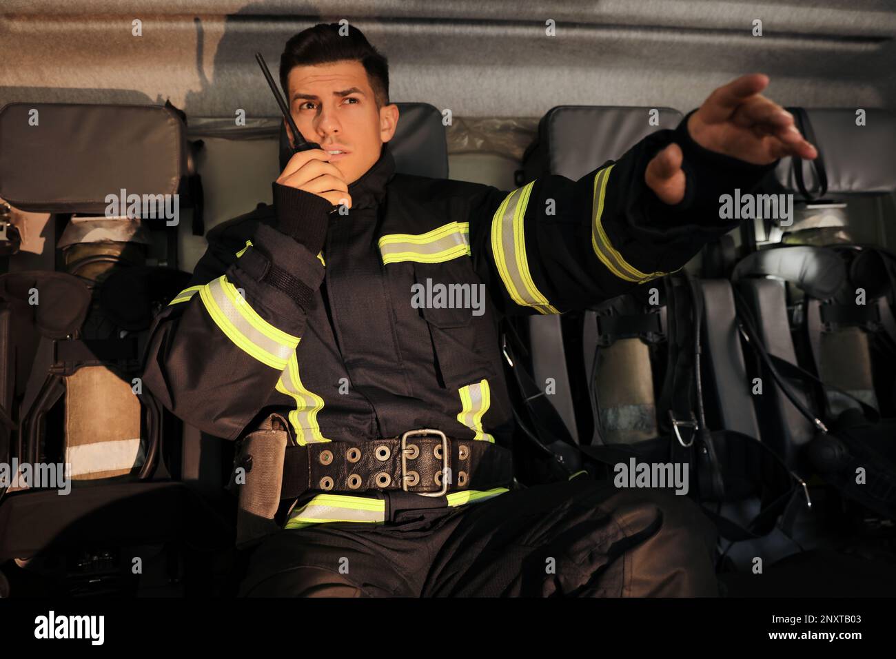 Firefighter using portable radio set in fire truck Stock Photo - Alamy