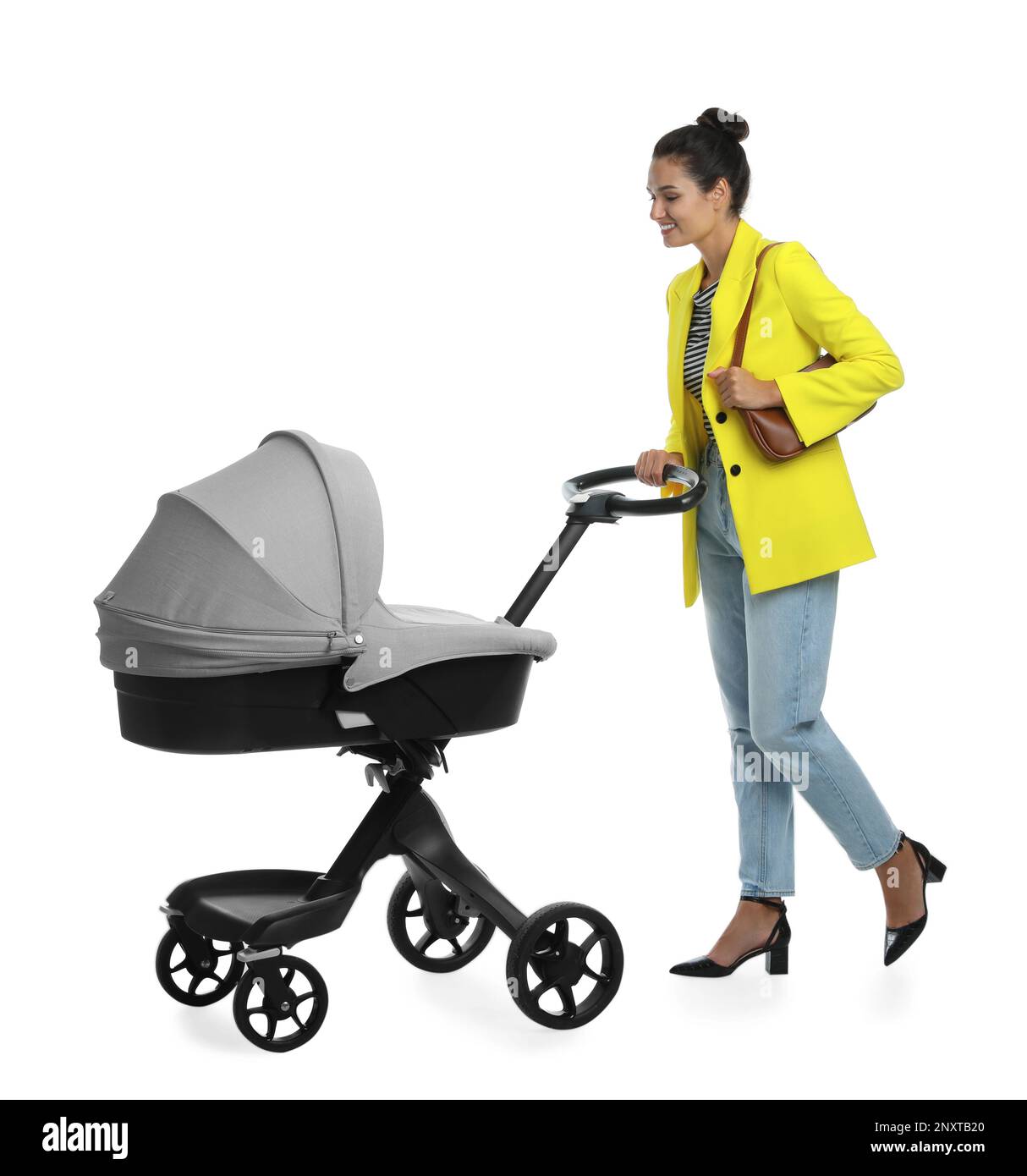 Happy young woman with baby stroller on white background Stock Photo ...