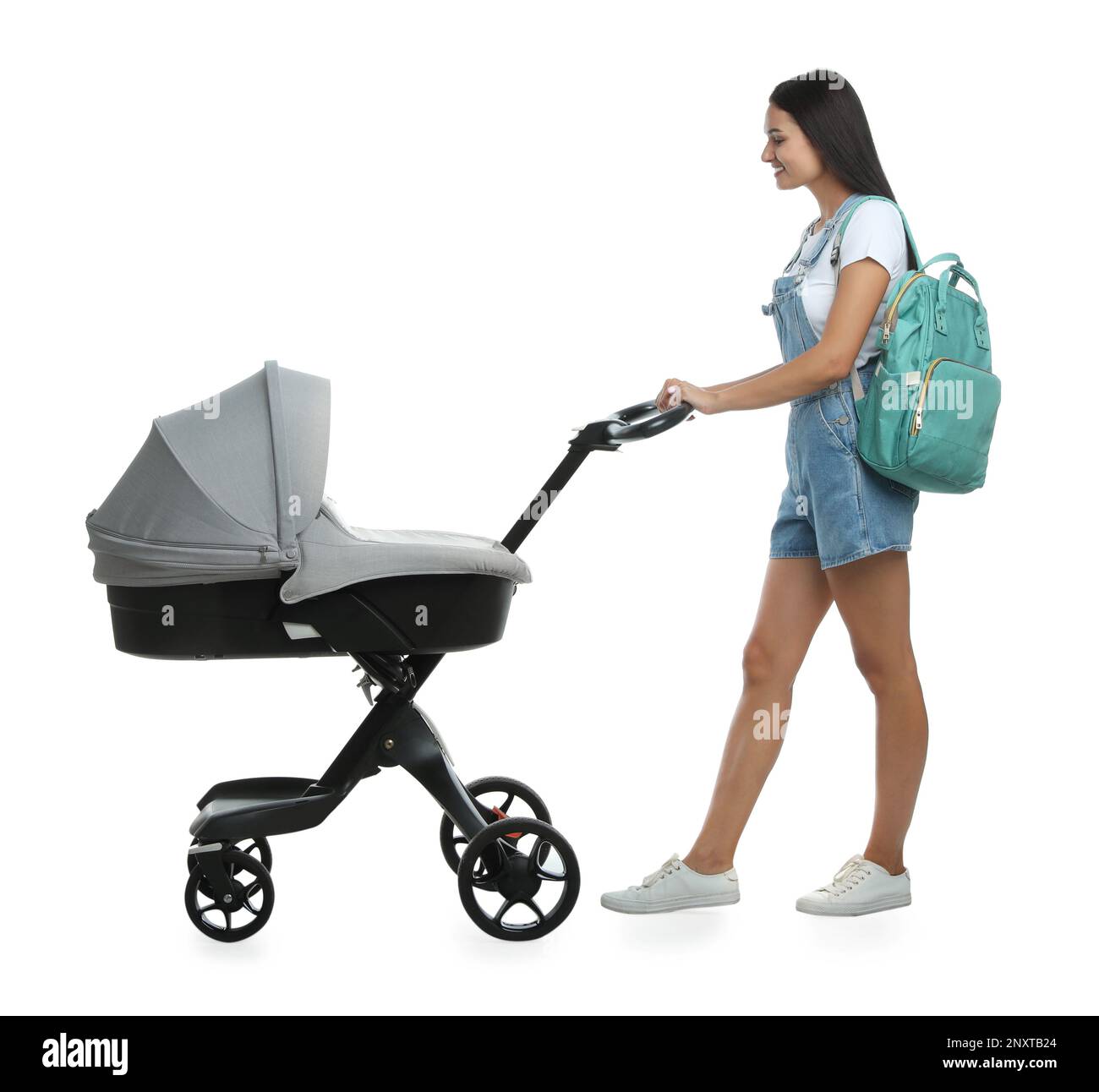 Happy young woman with baby stroller on white background Stock Photo ...
